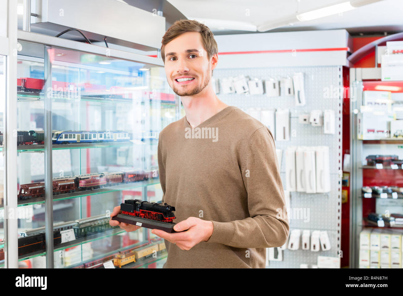 man in toy store buying model railroad Stock Photo - Alamy