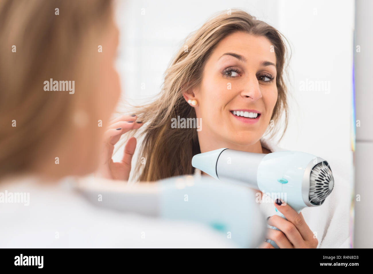 Woman drying hair in front hi-res stock photography and images - Alamy