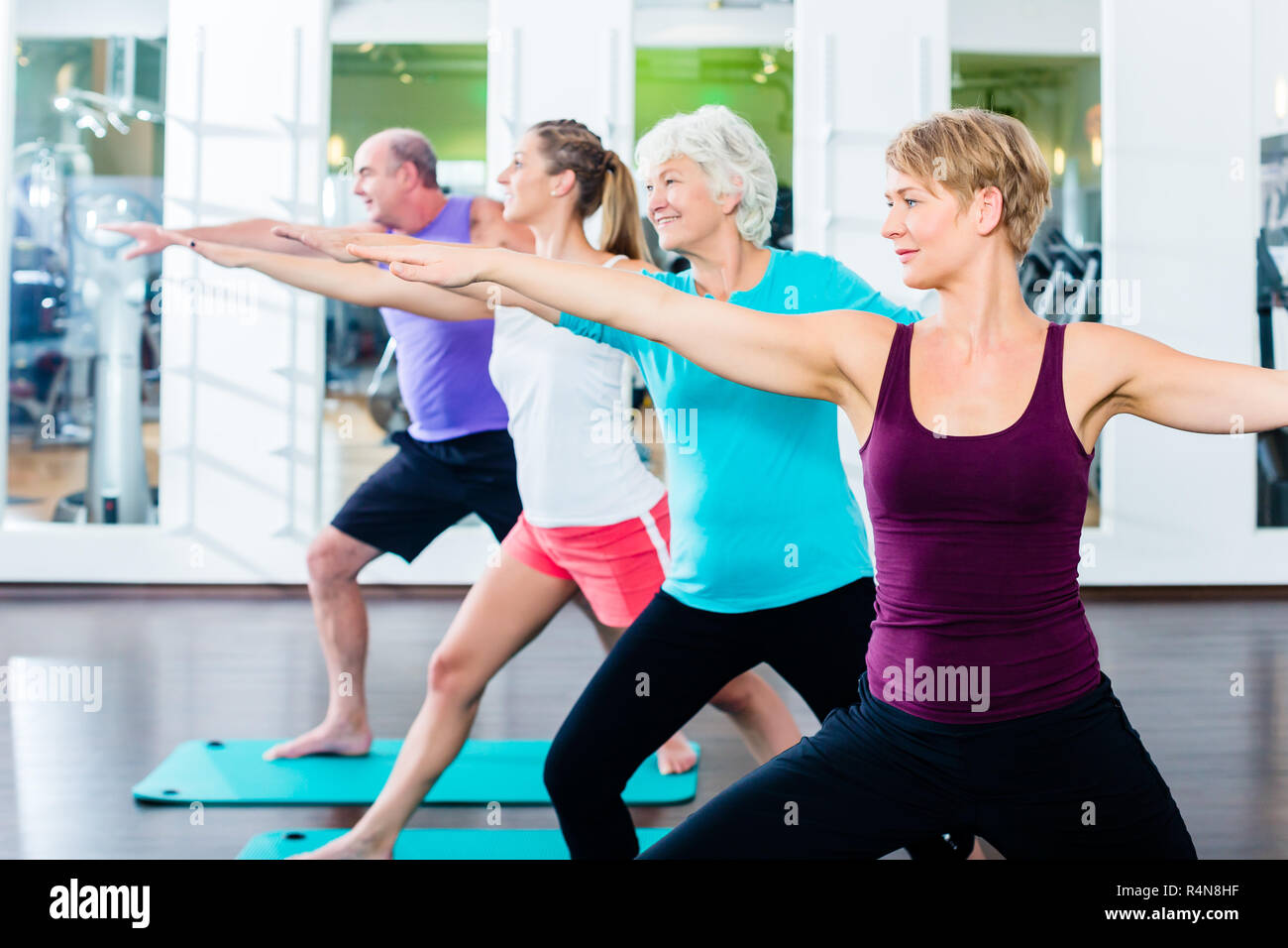 Senior and young people doing gymnastics in gym Stock Photo - Alamy
