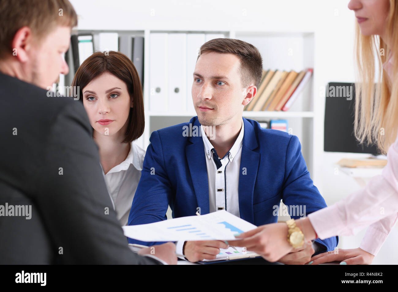Group of people sit in office deliberate Stock Photo - Alamy