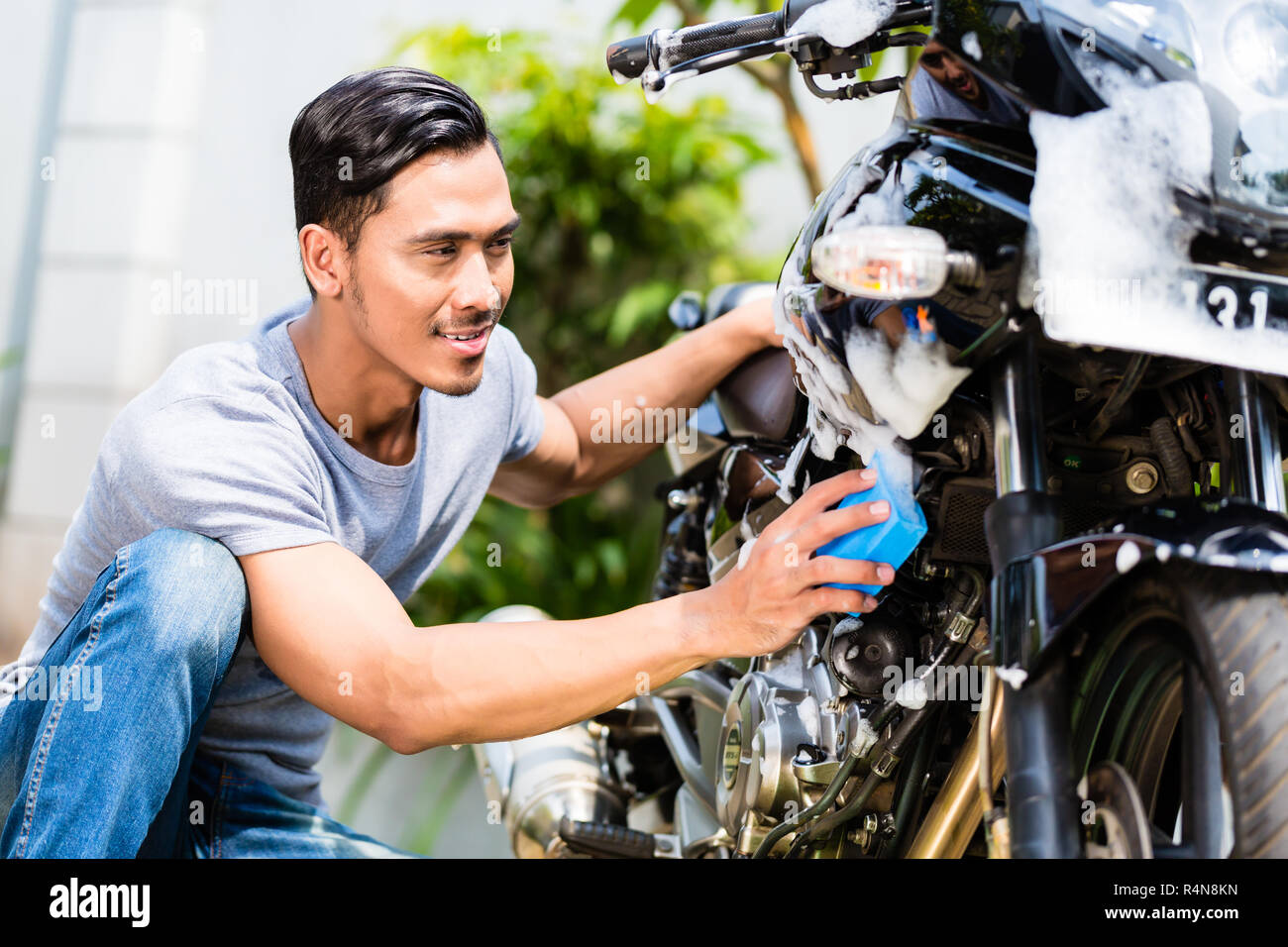 Asian indonesian man washing motorcycle hi-res stock photography and ...