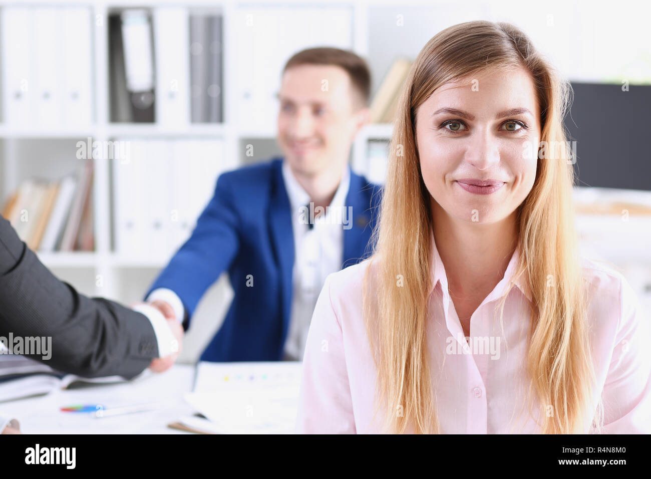 Beautiful smiling cheerful girl at workplace Stock Photo - Alamy