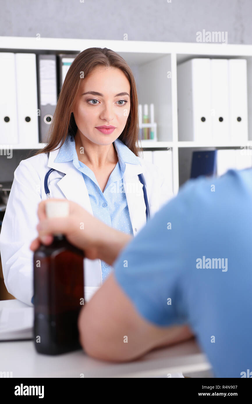 Beautiful female doctor and sleepy alcoholic Stock Photo - Alamy