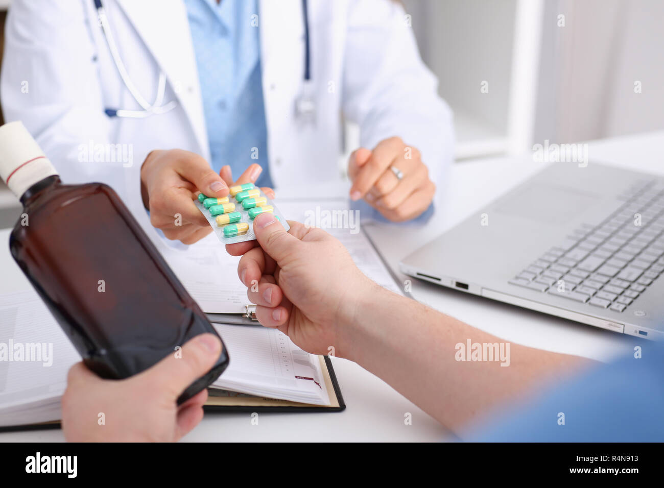 Alcoholic hold in arm empty bottle and medication Stock Photo - Alamy