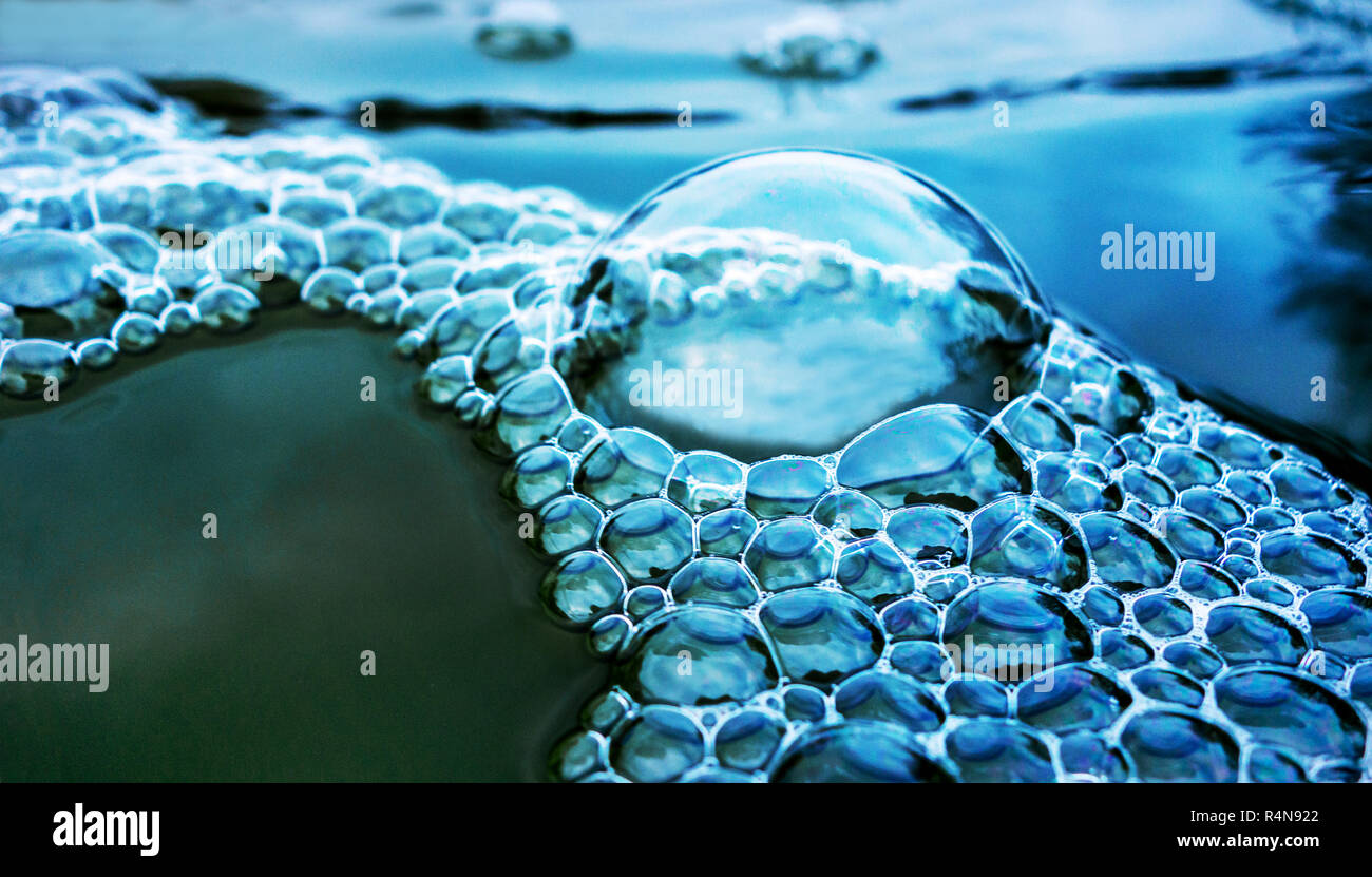 Closeup of a large bubble and a Cluster of bubbles made by a water ...