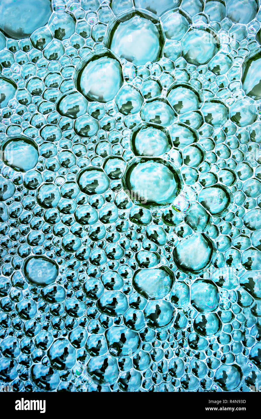 Cluster of bubbles made by a water fountain in an English garden pond ...