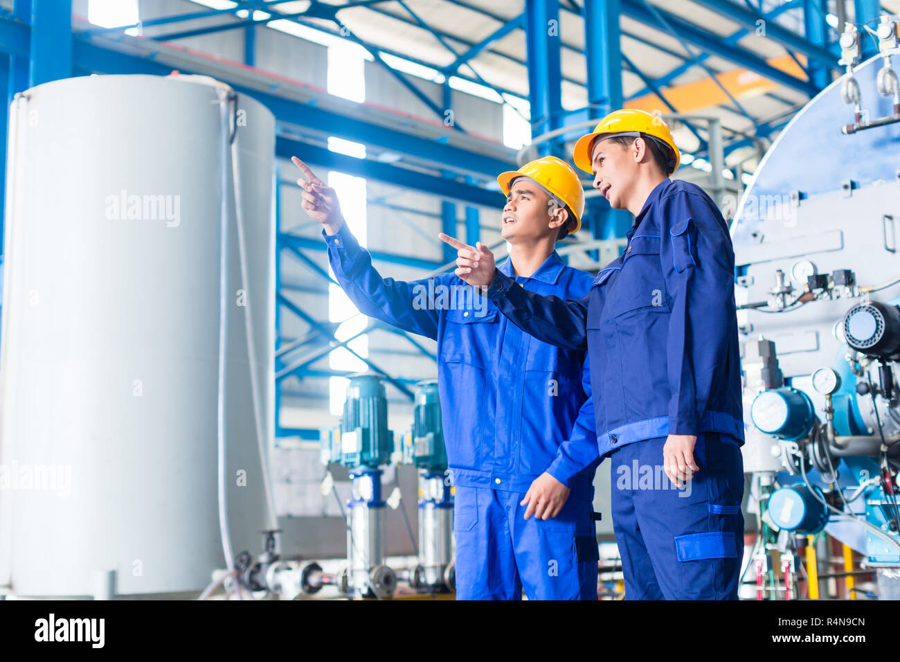 Worker in Asian manufacturing plant Stock Photo - Alamy