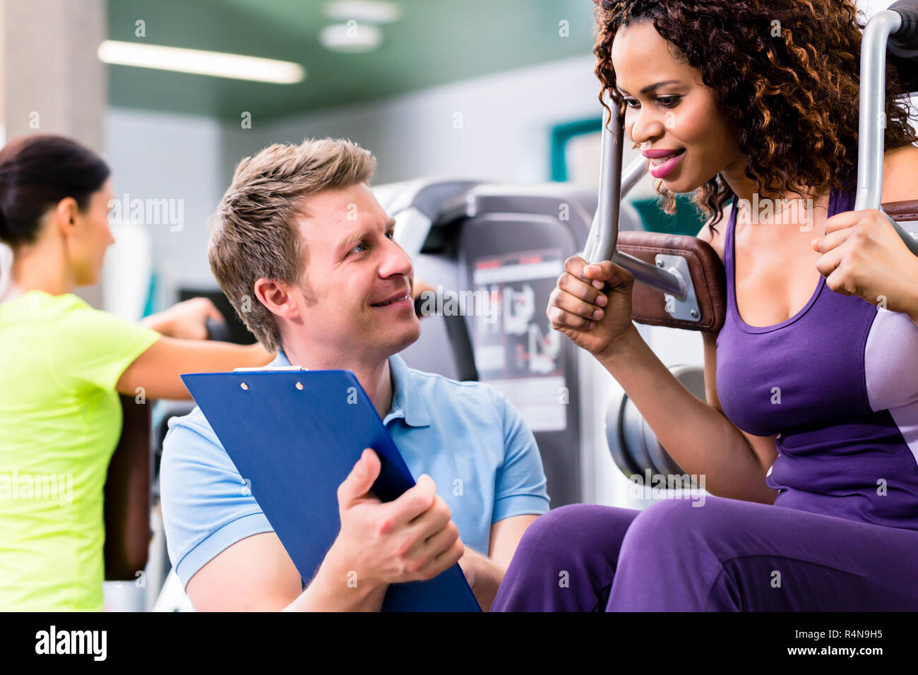 Fitness training in gym - black woman and personal trainer Stock Photo ...