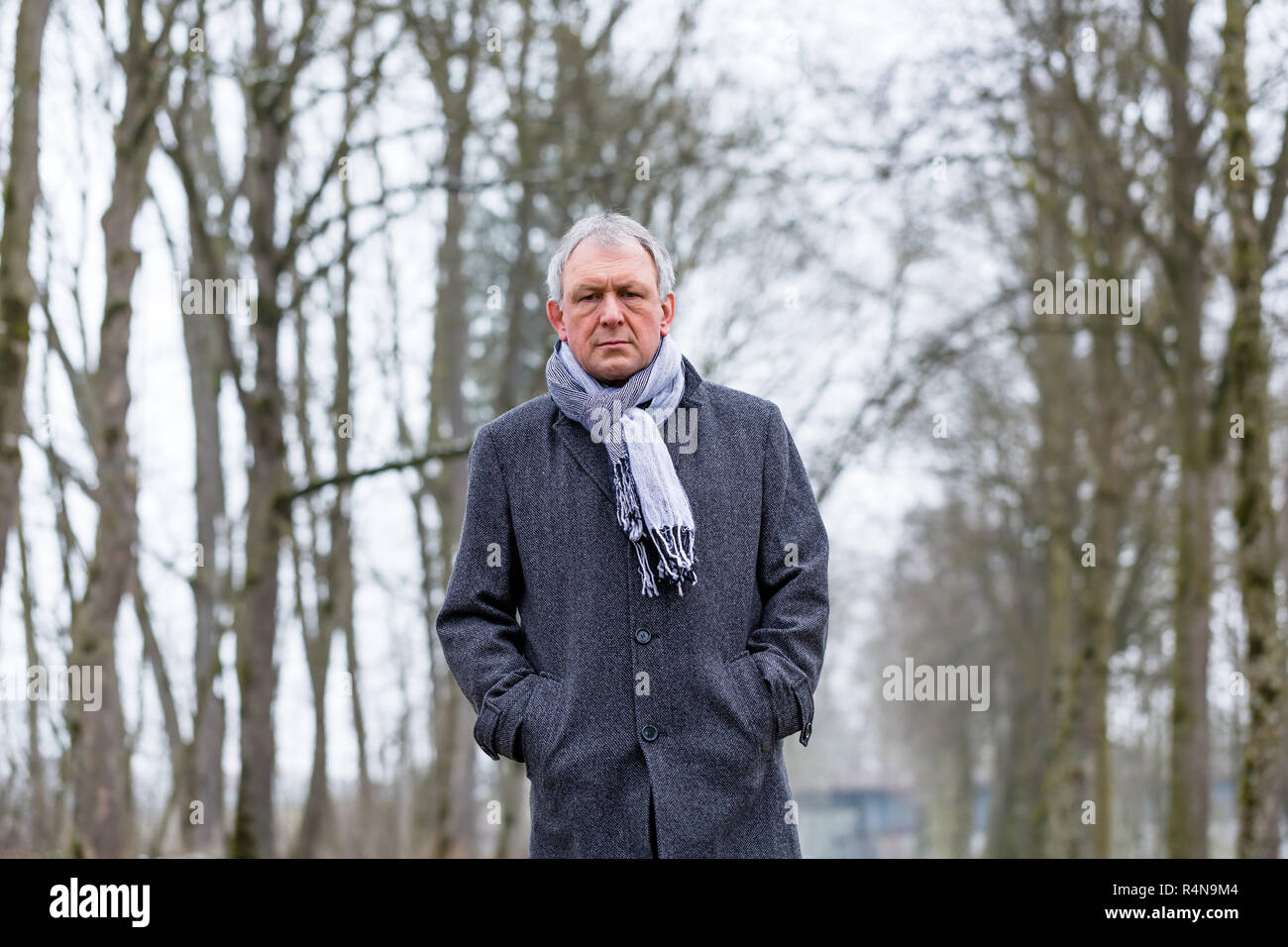Depressed or sad man walking in winter Stock Photo - Alamy