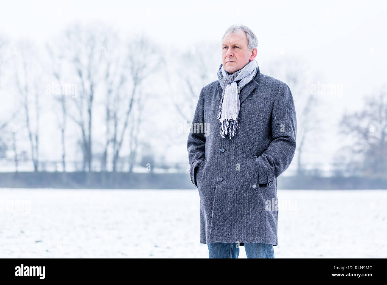Depressed or sad man walking in winter Stock Photo - Alamy