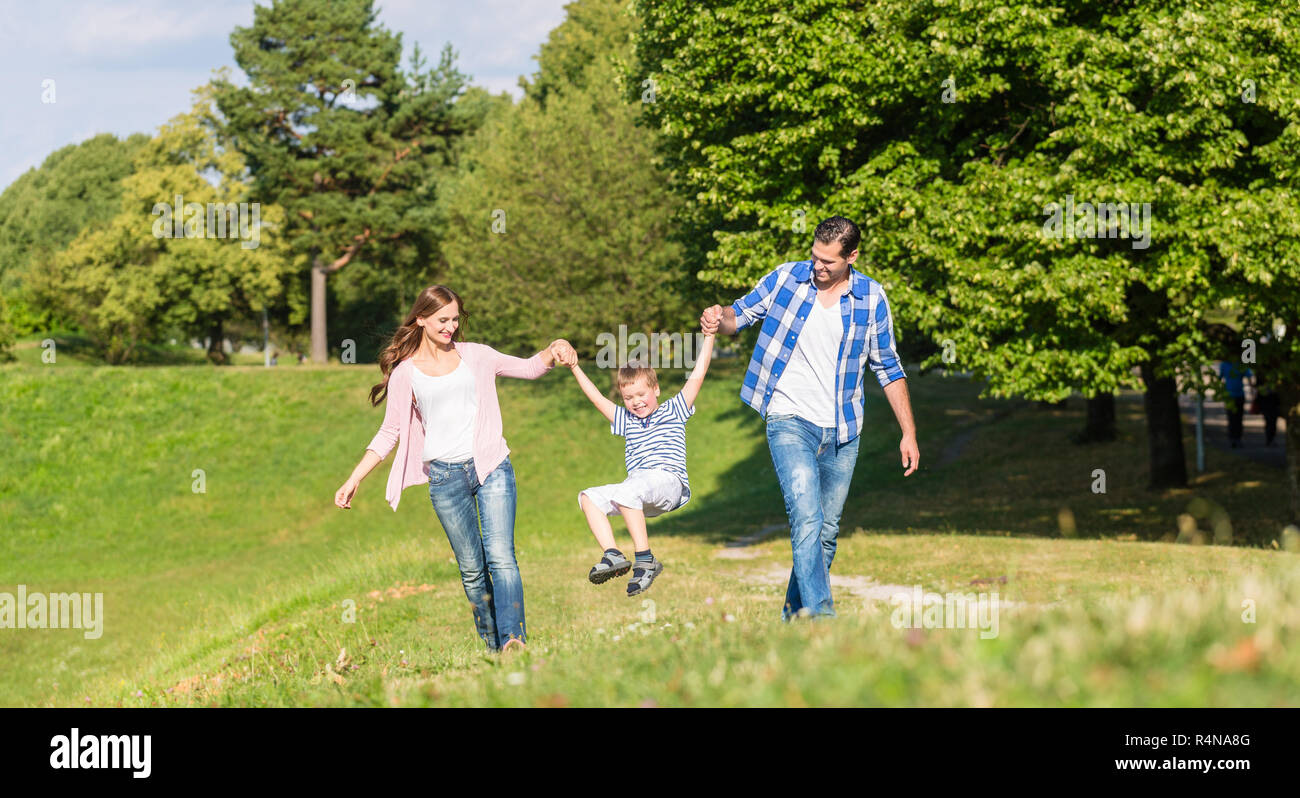 Family having walk holding hands Stock Photo - Alamy