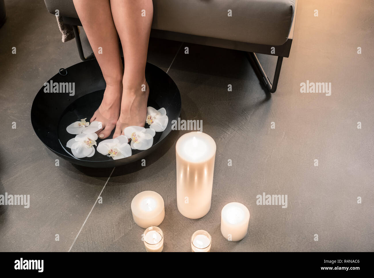 Female feet during Asian therapeutic washing at luxury beauty center ...