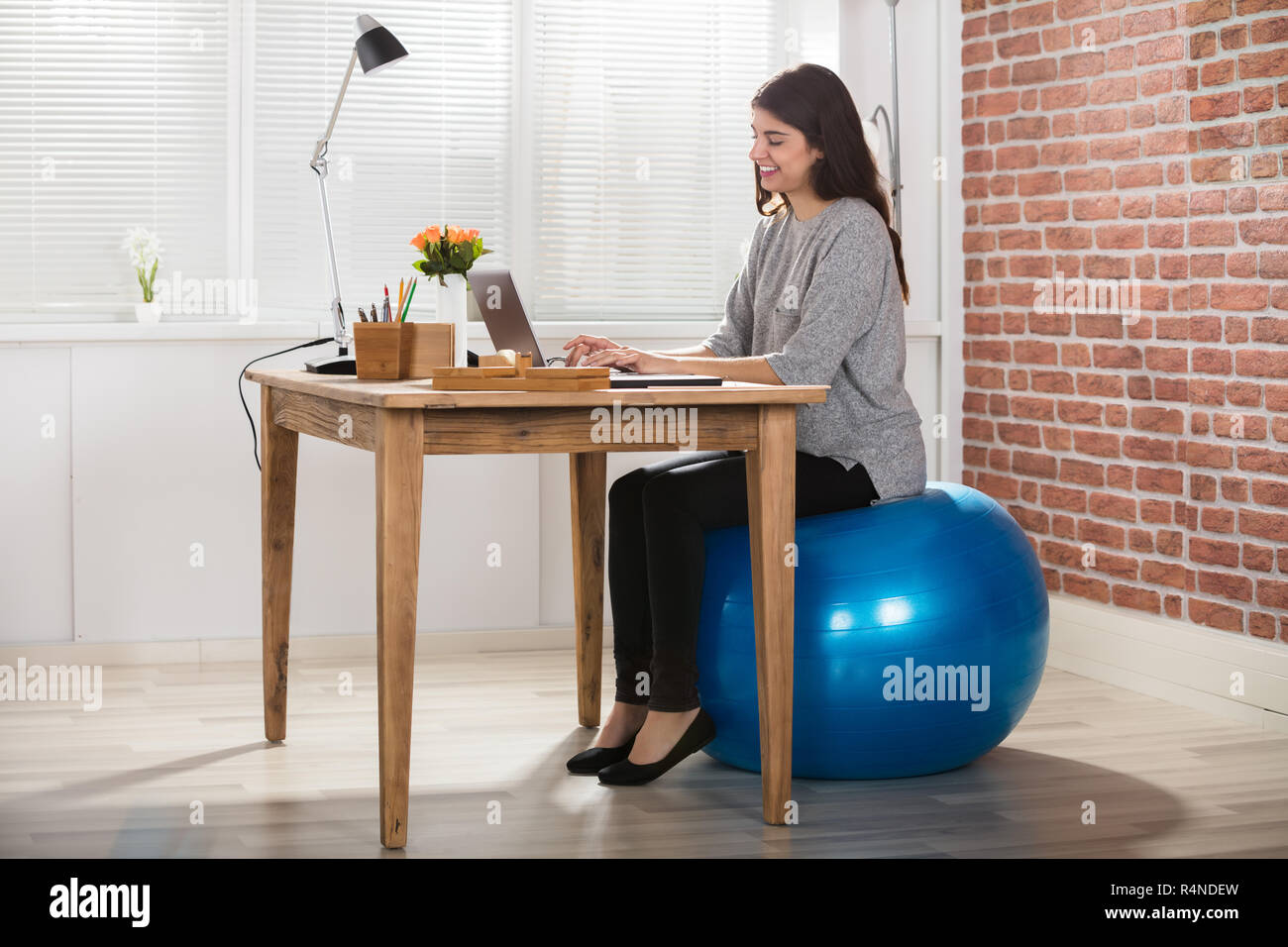 Female office using exercise ball hi-res stock photography and images ...