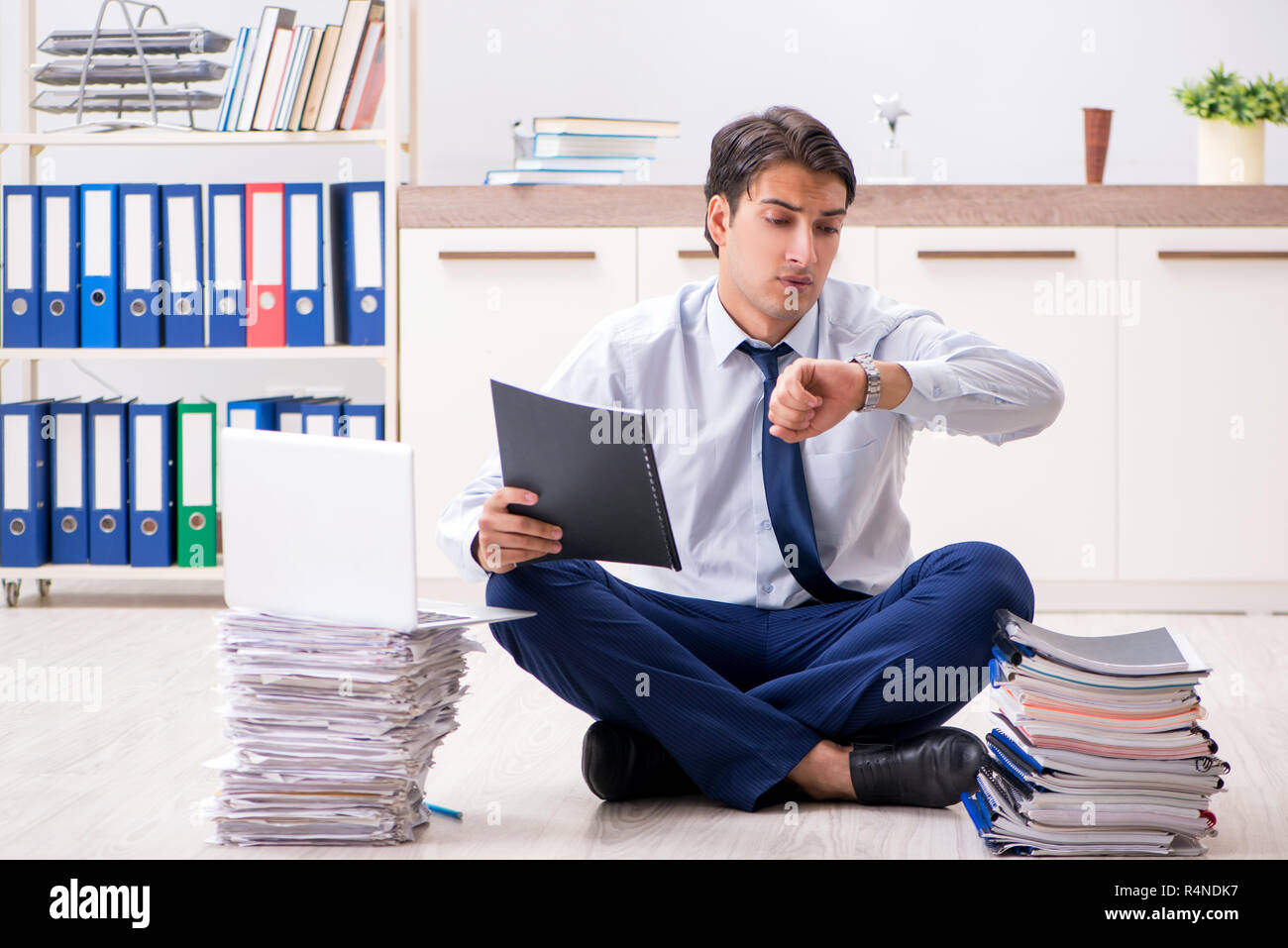 Extremely busy employee working in the office Stock Photo - Alamy