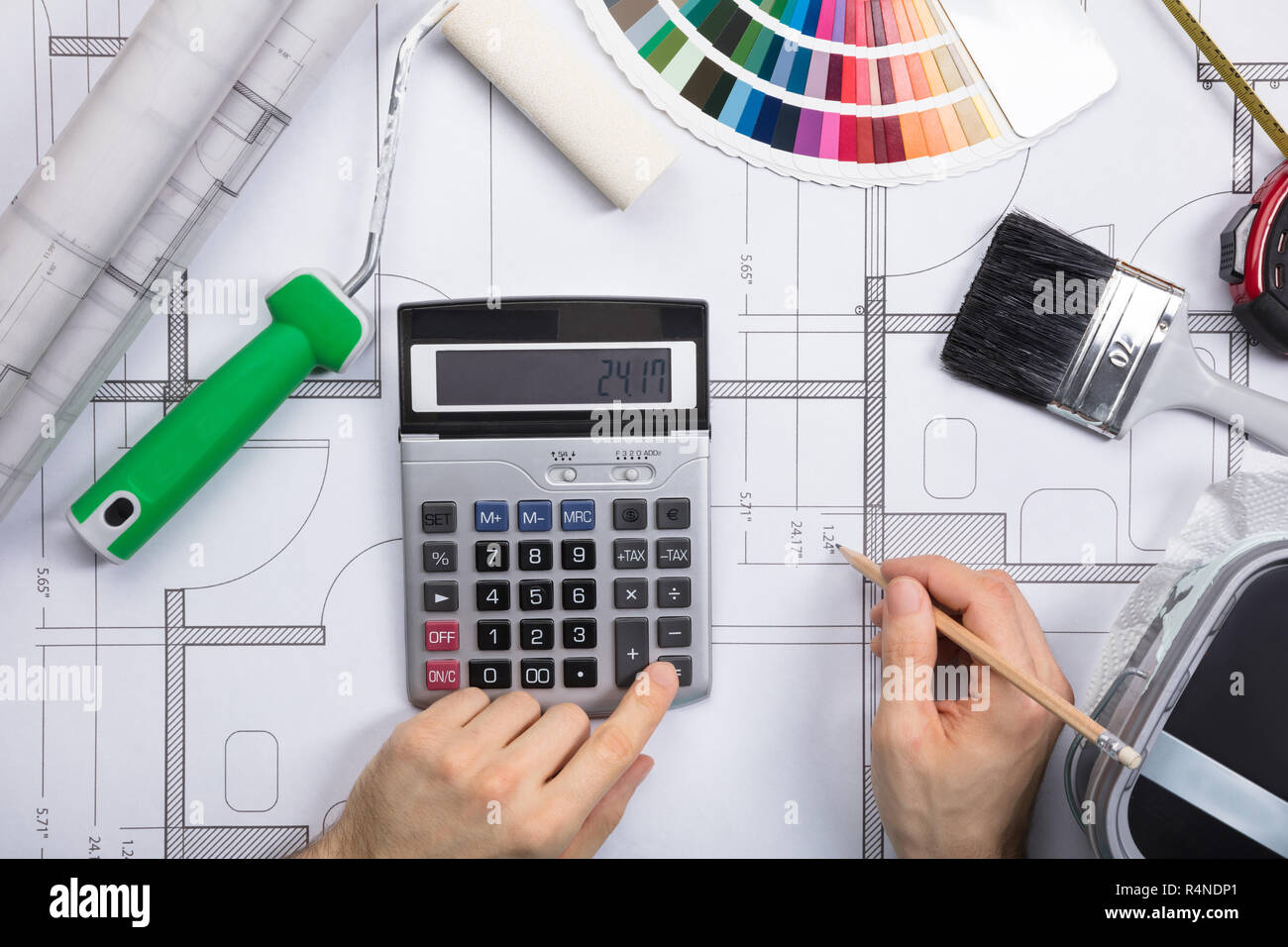 An Architect Drawing Plan On Blueprint Using Calculator Stock Photo - Alamy
