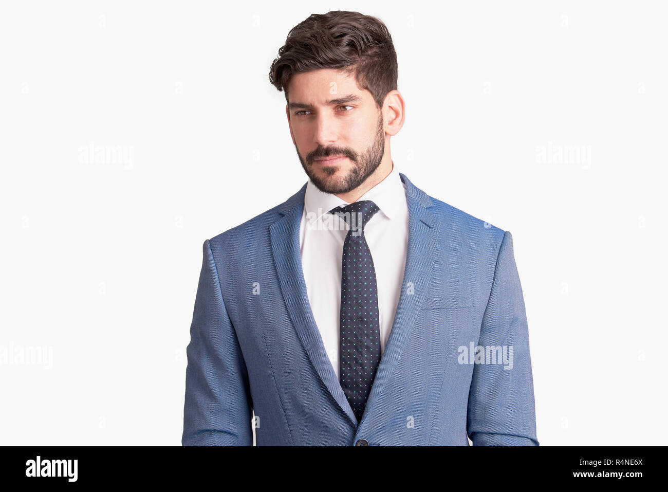 Studio portrait of handsome young businessman wearing suit and tie ...