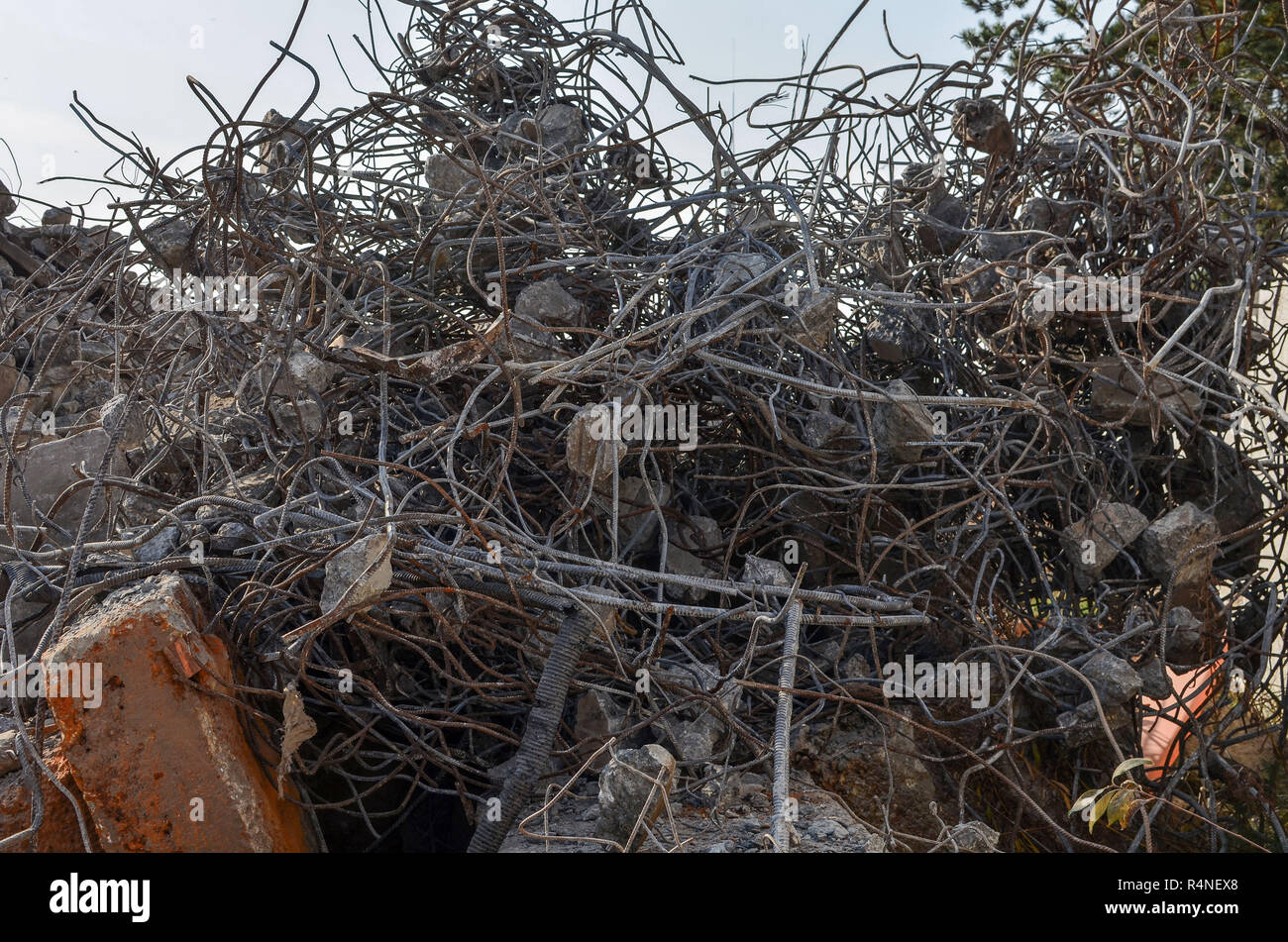 A heap of construction debris: Armature, iron round rods, pieces of ...