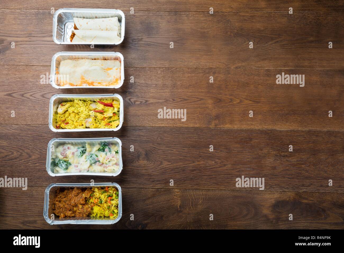 Row Of Take Away Dishes On Wooden Table Stock Photo - Alamy