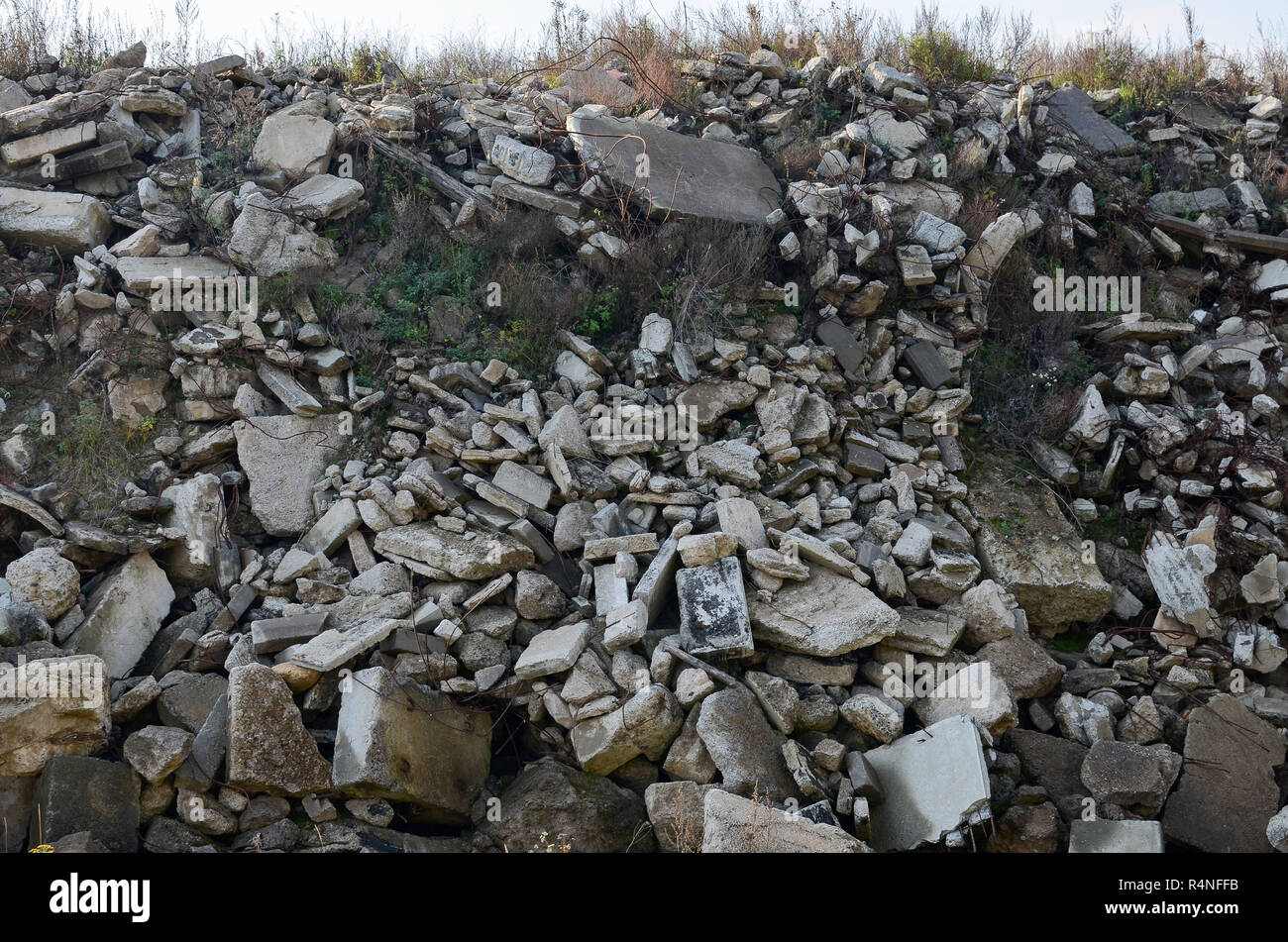Construction waste, reinforced concrete blocks and rusty fittings ...