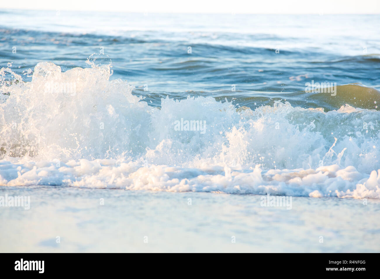 Sea wave breaking Stock Photo - Alamy