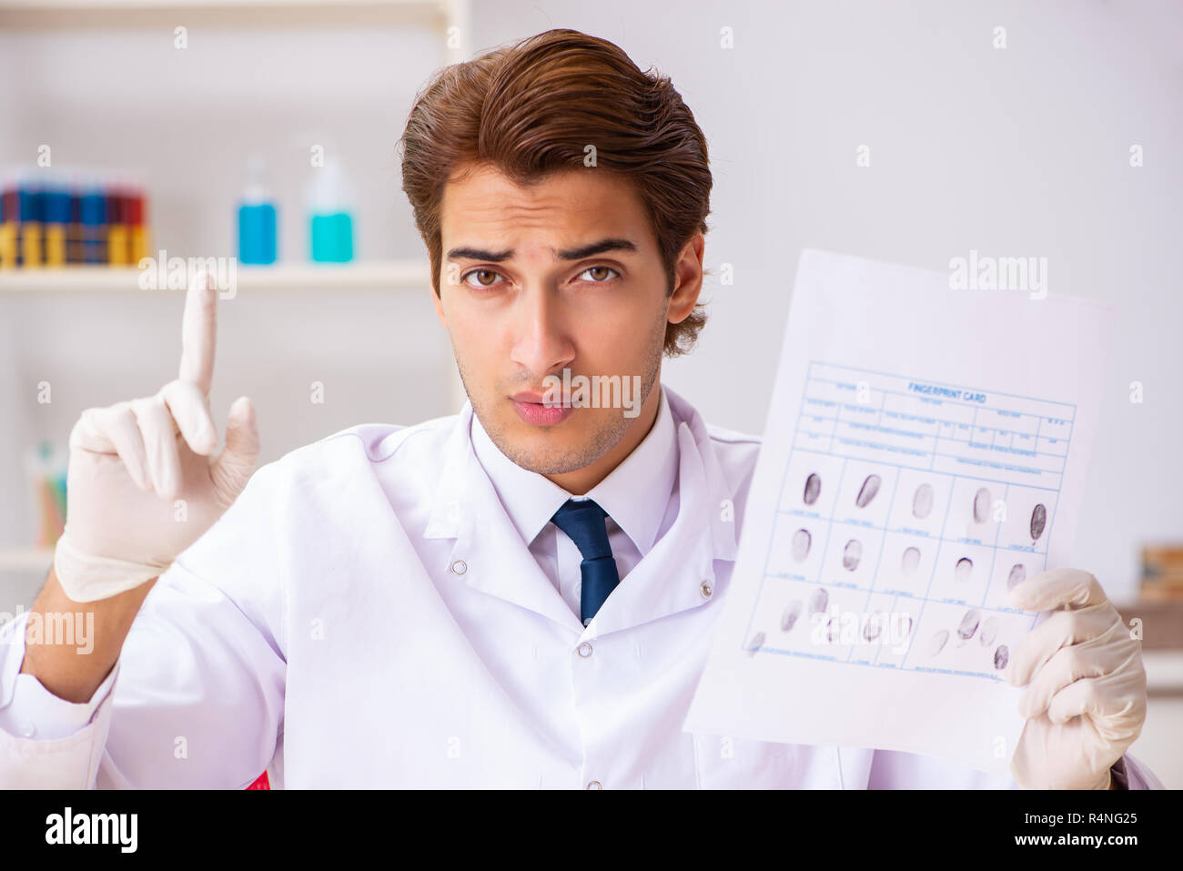 Forensic expert studying fingerprints in the lab Stock Photo - Alamy