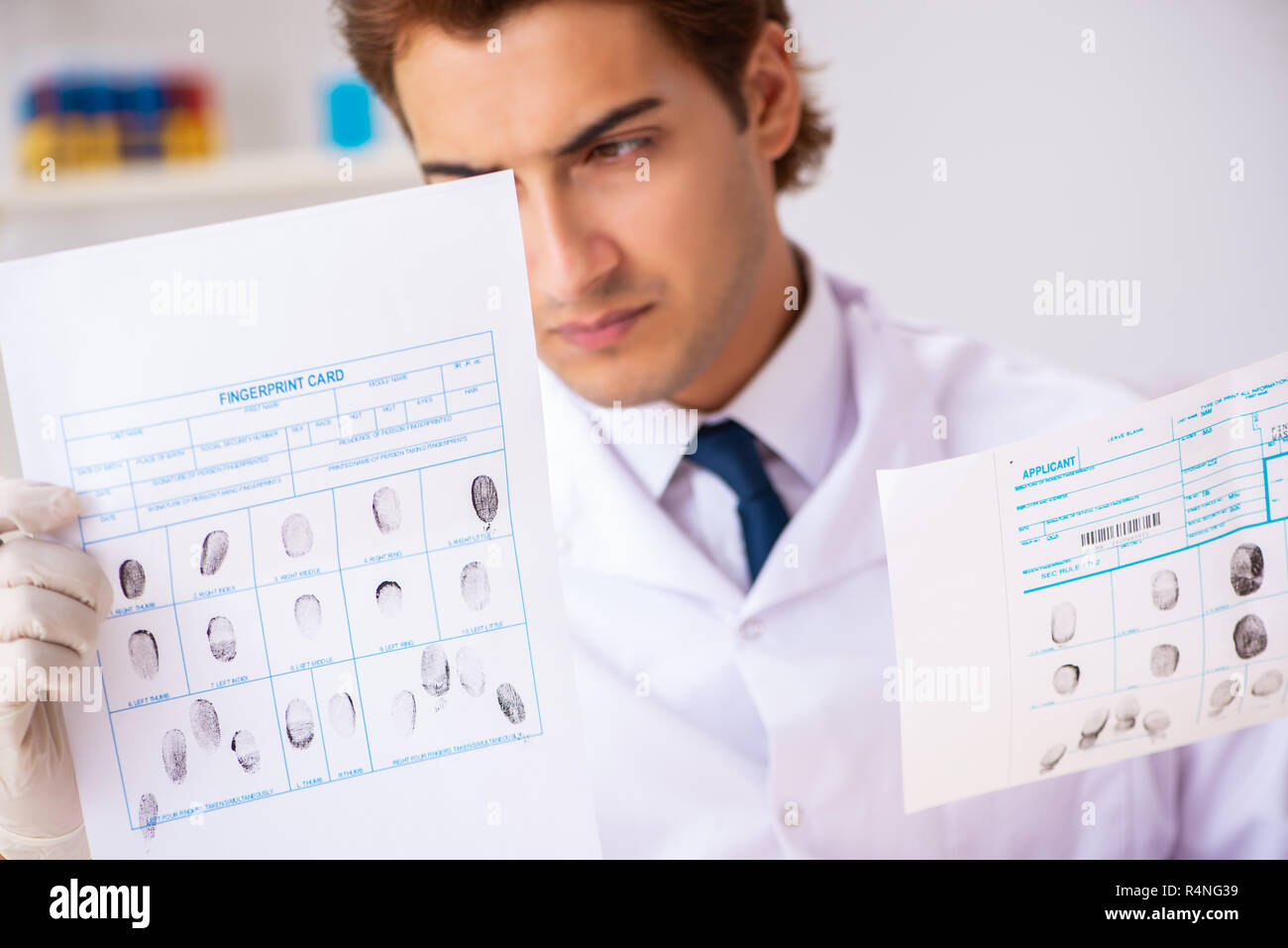 Forensic expert studying fingerprints in the lab Stock Photo - Alamy
