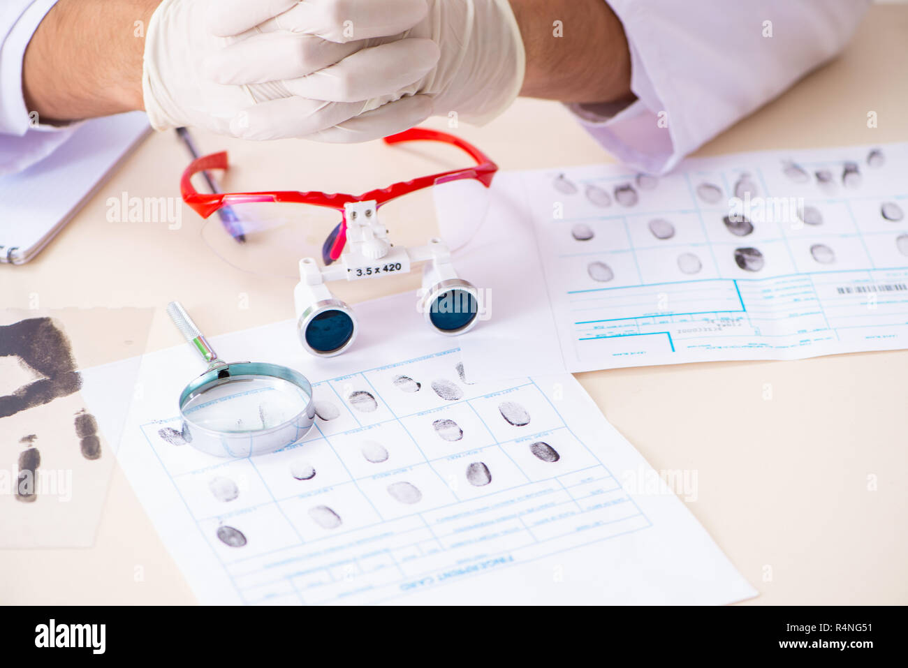 Forensic expert studying fingerprints in the lab Stock Photo - Alamy