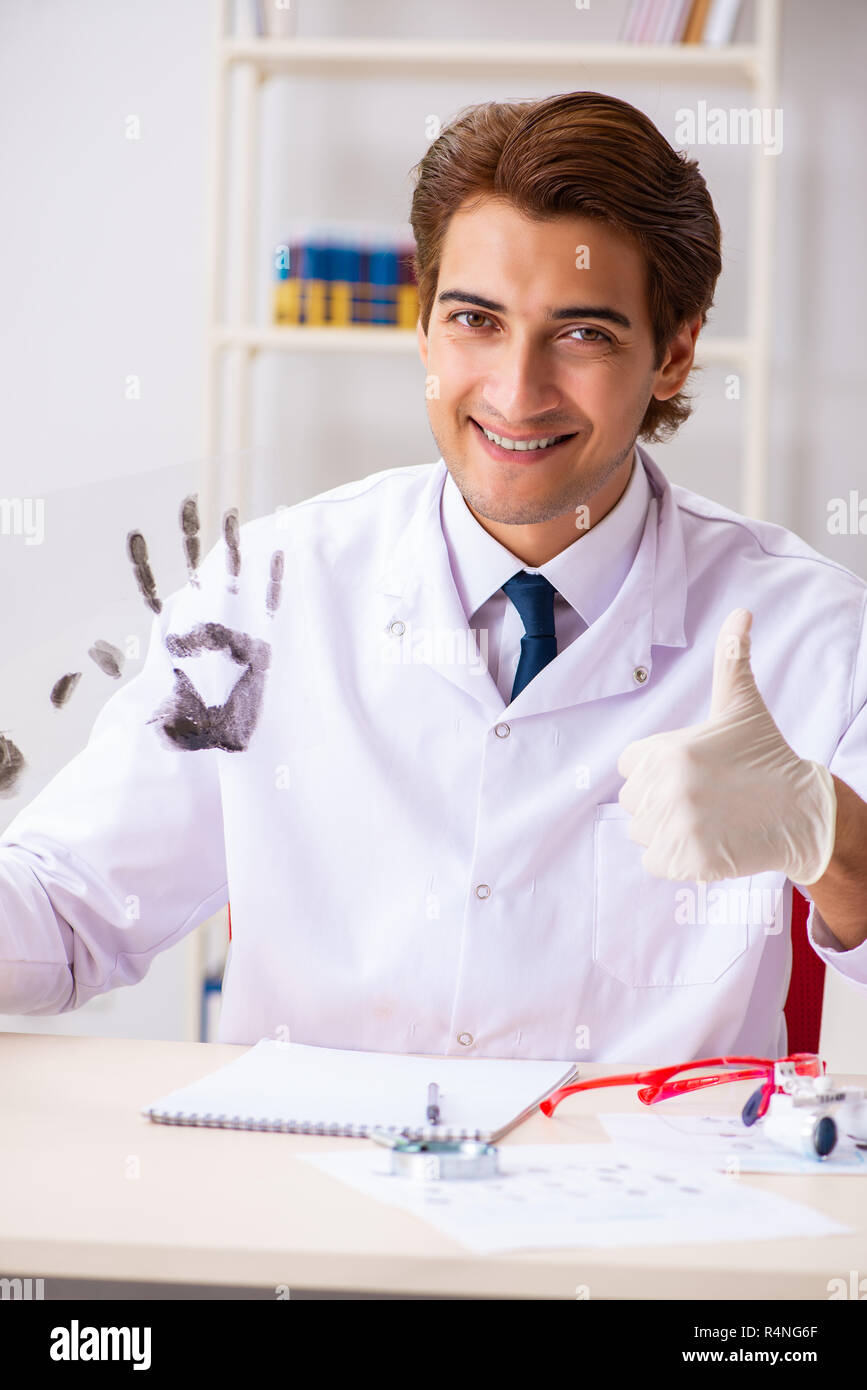 Forensic expert studying fingerprints in the lab Stock Photo - Alamy