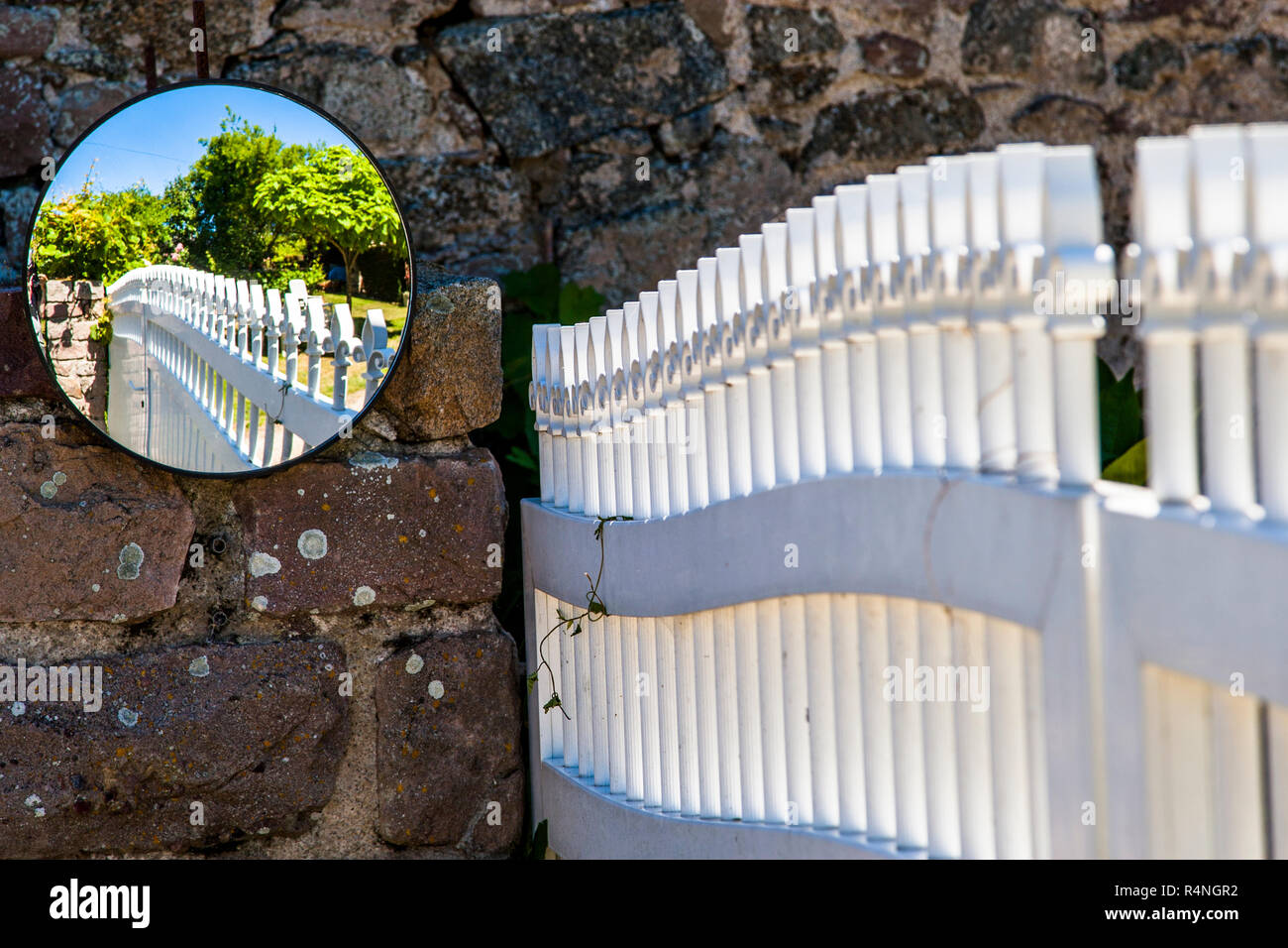 Gate with traffic mirror Stock Photo - Alamy