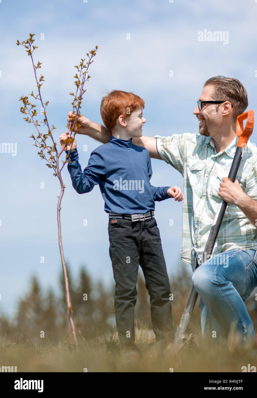 happy father and son planted a tree together Stock Photo - Alamy