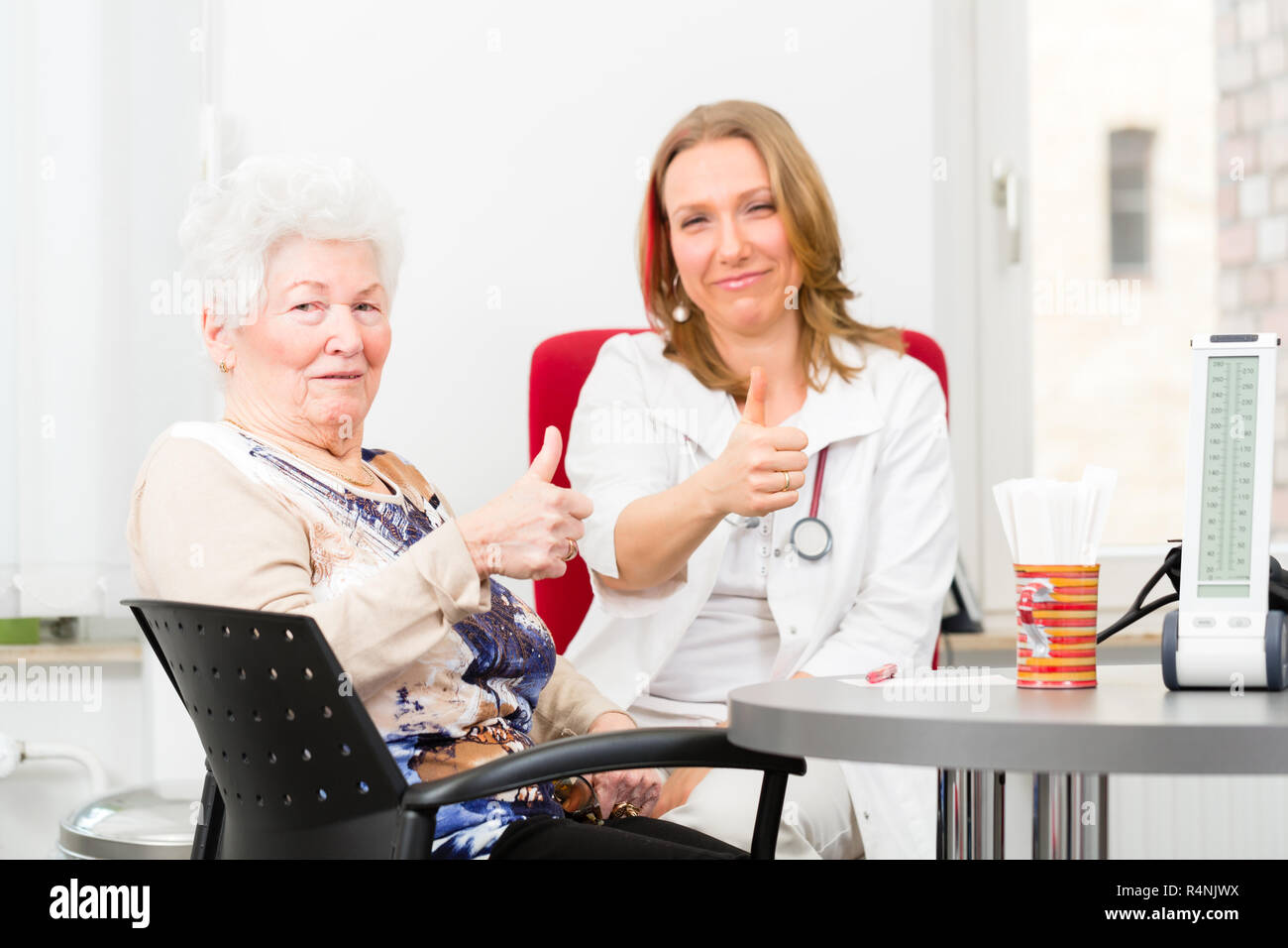 Doctor seeing senior patient in practice Stock Photo - Alamy