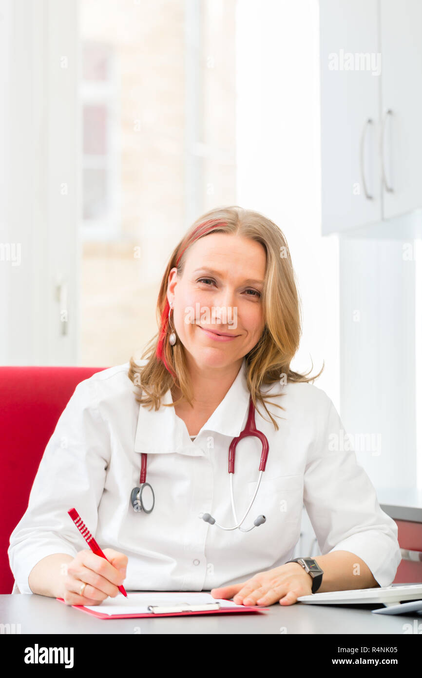 Doctor writing medical prescription in surgery Stock Photo - Alamy