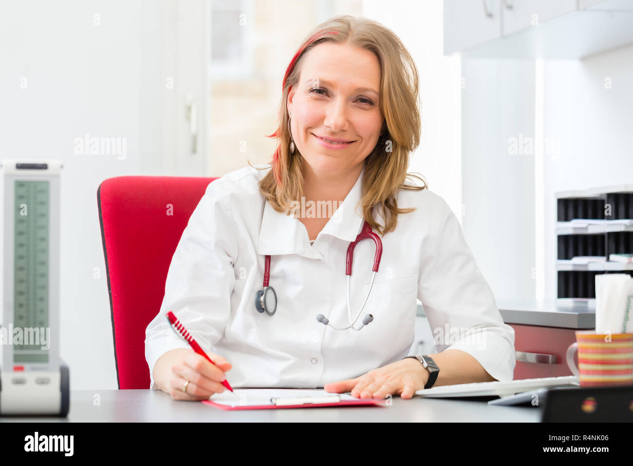 Doctor writing medical prescription in surgery Stock Photo - Alamy