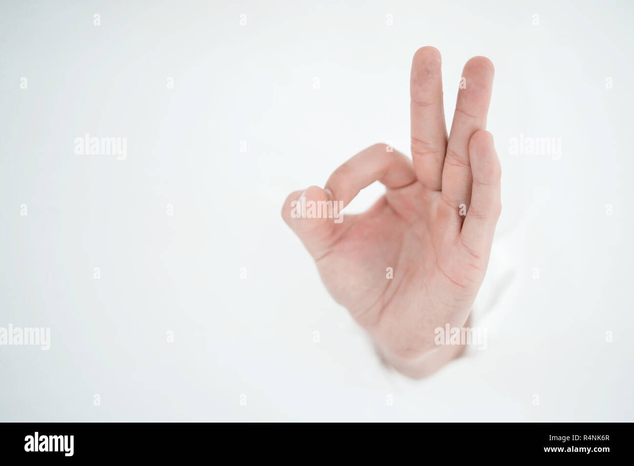 man's hand breaking through the paper wall and pointing at you Stock ...