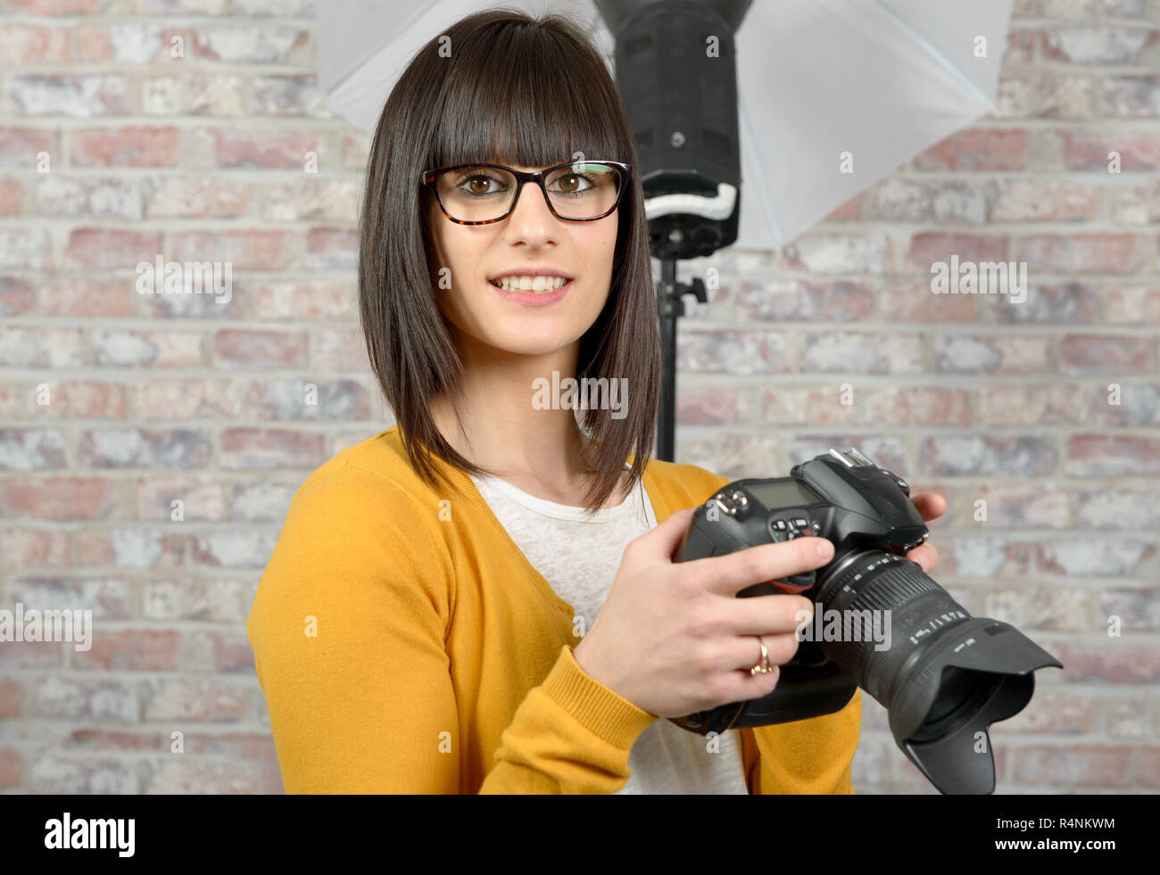 Attractive brunette woman with photo camera Stock Photo - Alamy