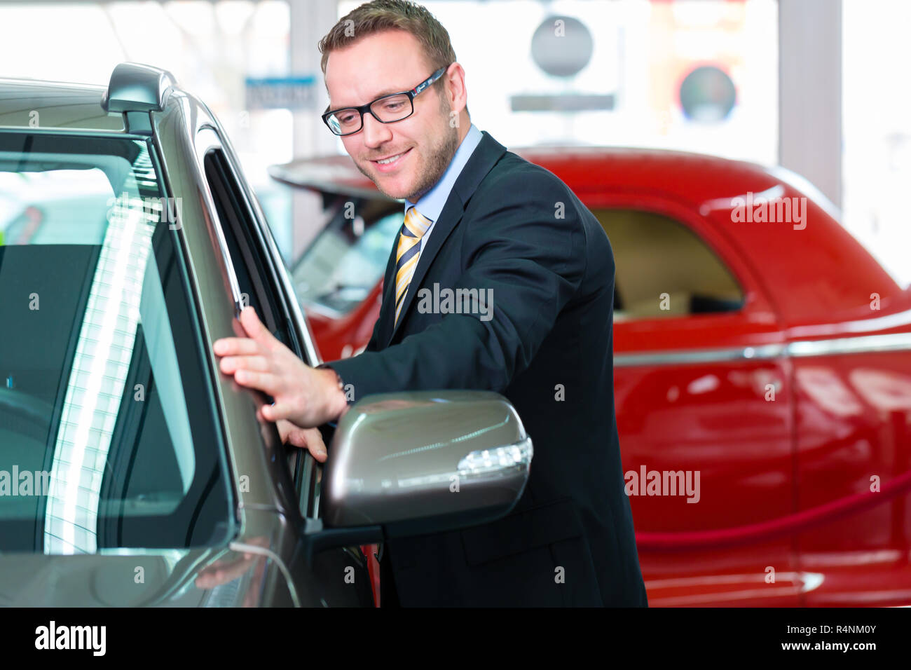 Salesman selling car at dealership Stock Photo - Alamy