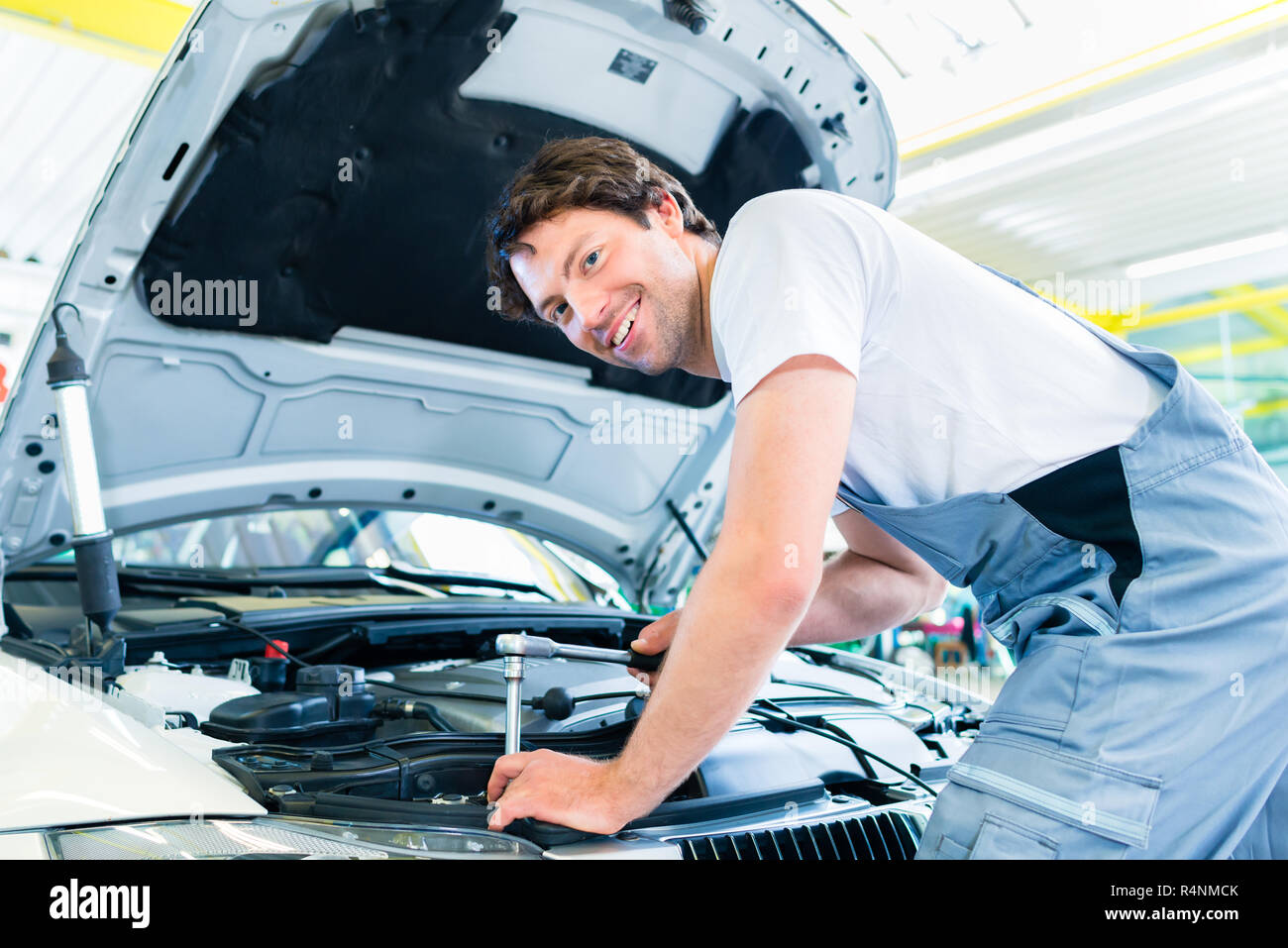 car mechanic working with tool in service workshop Stock Photo - Alamy