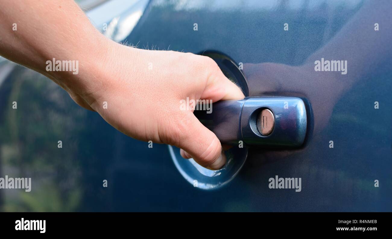 Hand opening car door Stock Photo - Alamy