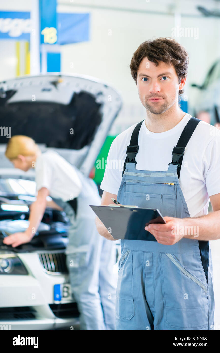 Car Mechanic team working in auto workshop Stock Photo - Alamy