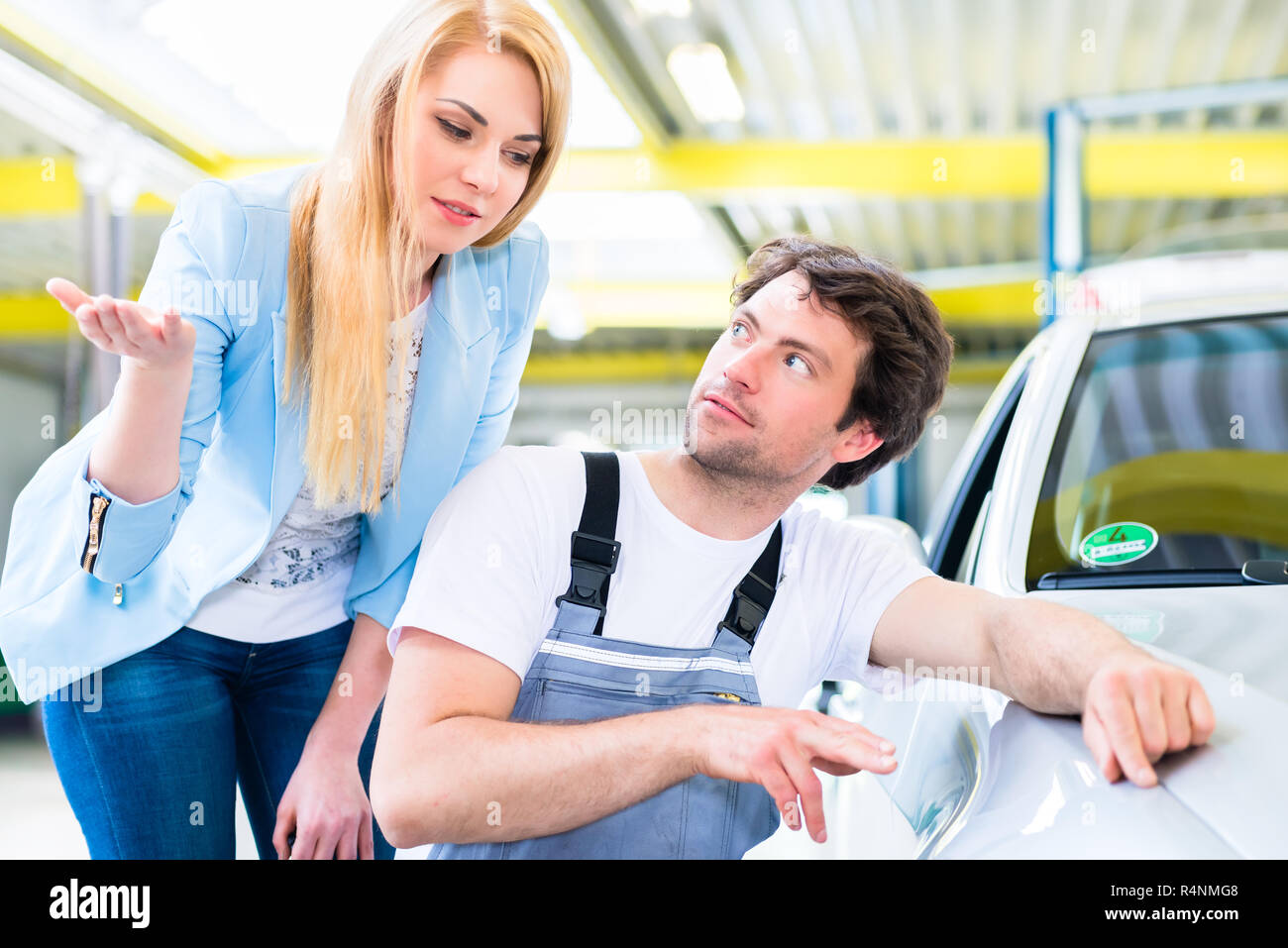 Customer and car painter in auto workshop Stock Photo - Alamy