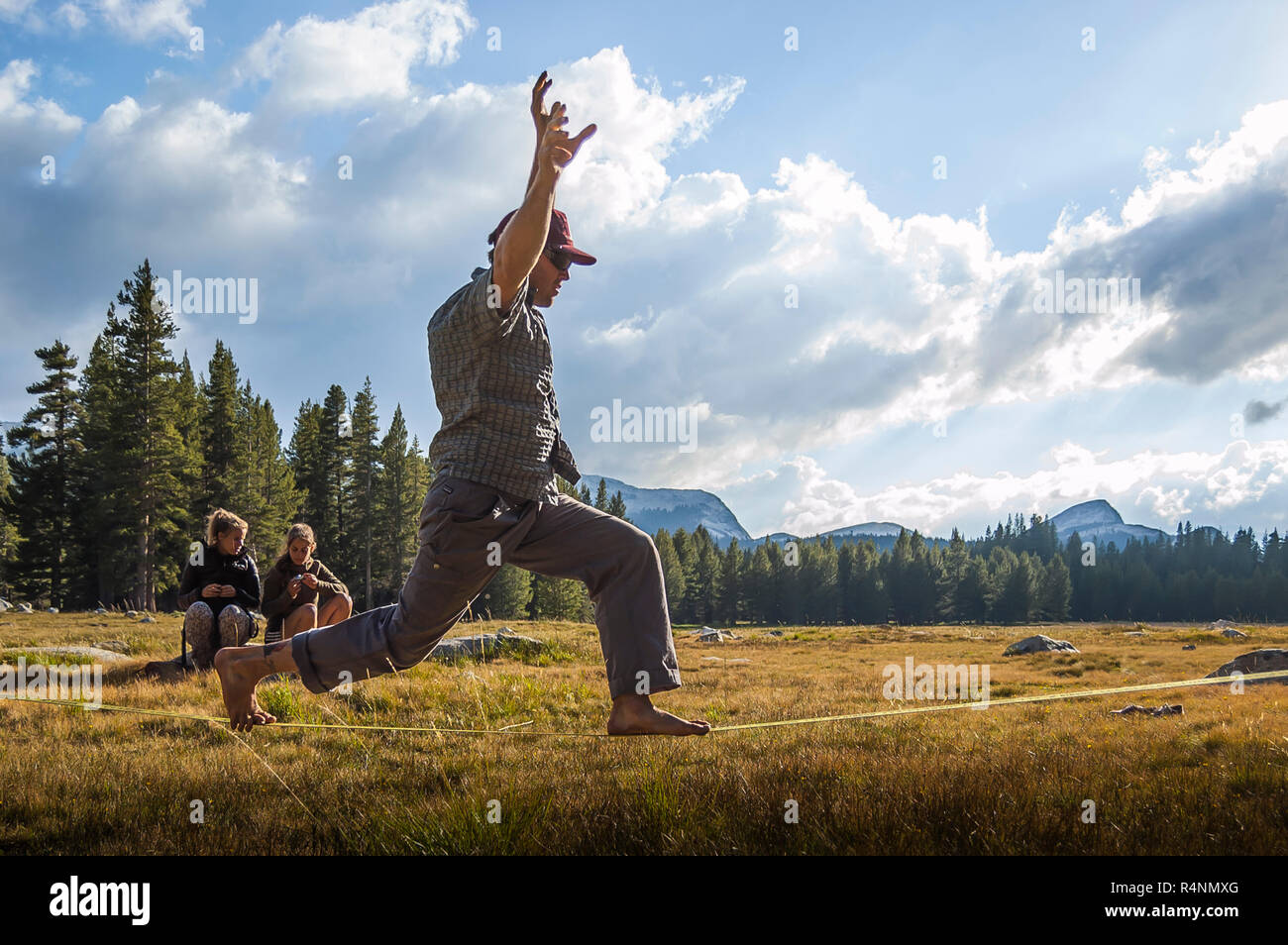 Side view of adventurous man balancing whileÂ slacklining, Â TuolumneÂ ...