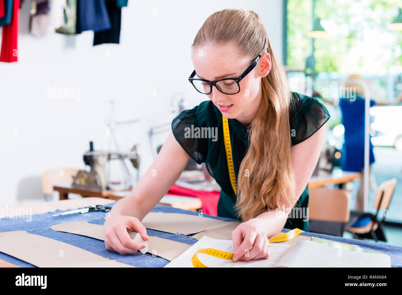 Tailor transfers pattern of fashion design to cloth Stock Photo - Alamy