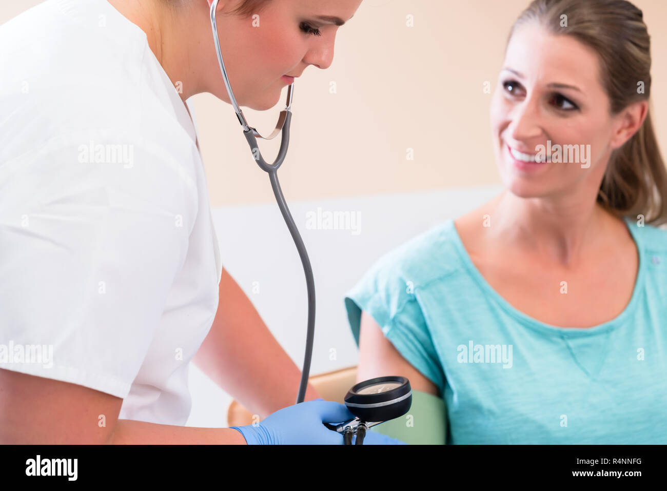 Nurse measuring blood pressure on woman Stock Photo - Alamy