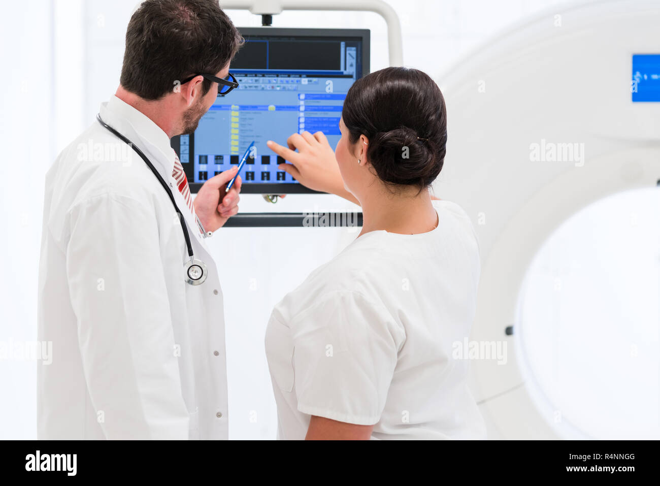 Doctor and nurse analyzing data of CT scan Stock Photo - Alamy
