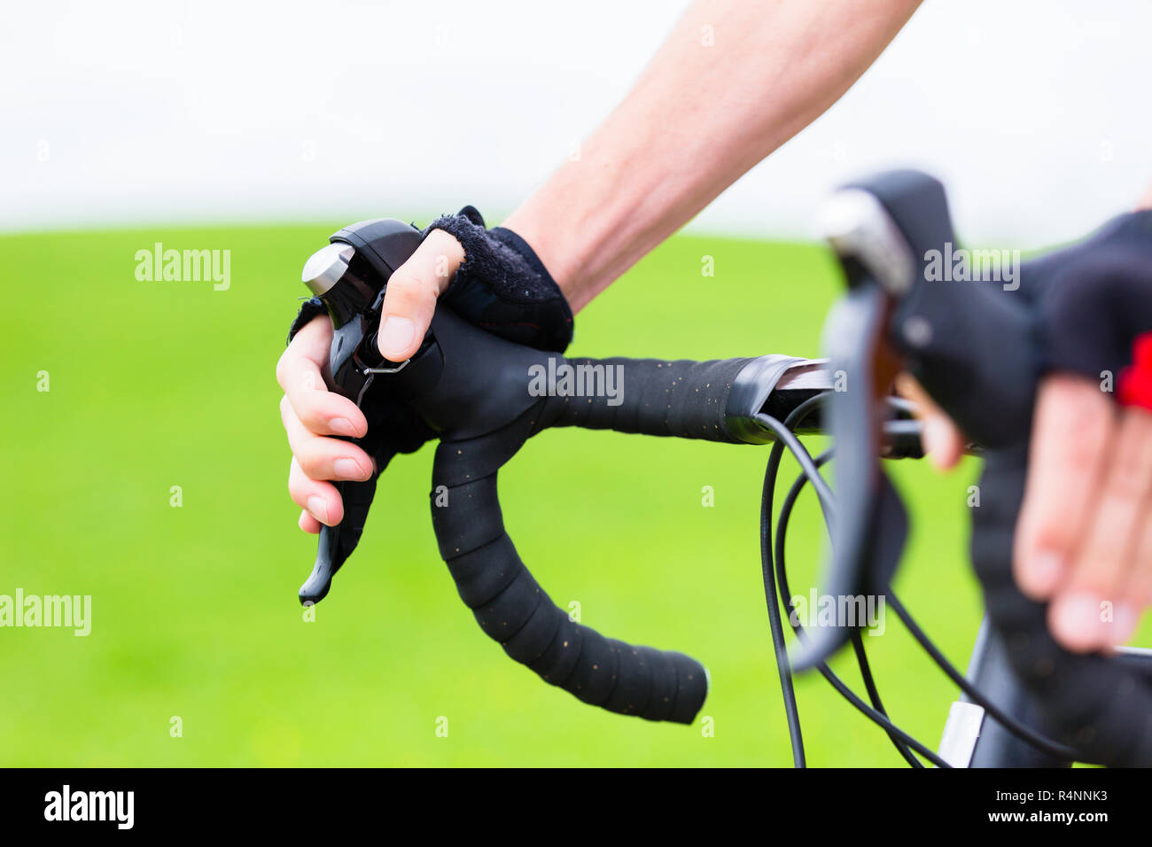 Sport man having Hands on handlebar of racing bike Stock Photo - Alamy