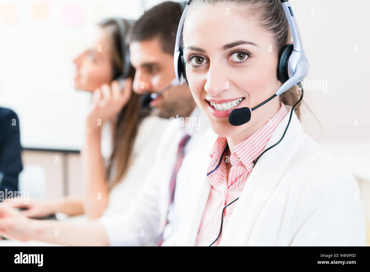 Woman and men working as call center agents Stock Photo - Alamy