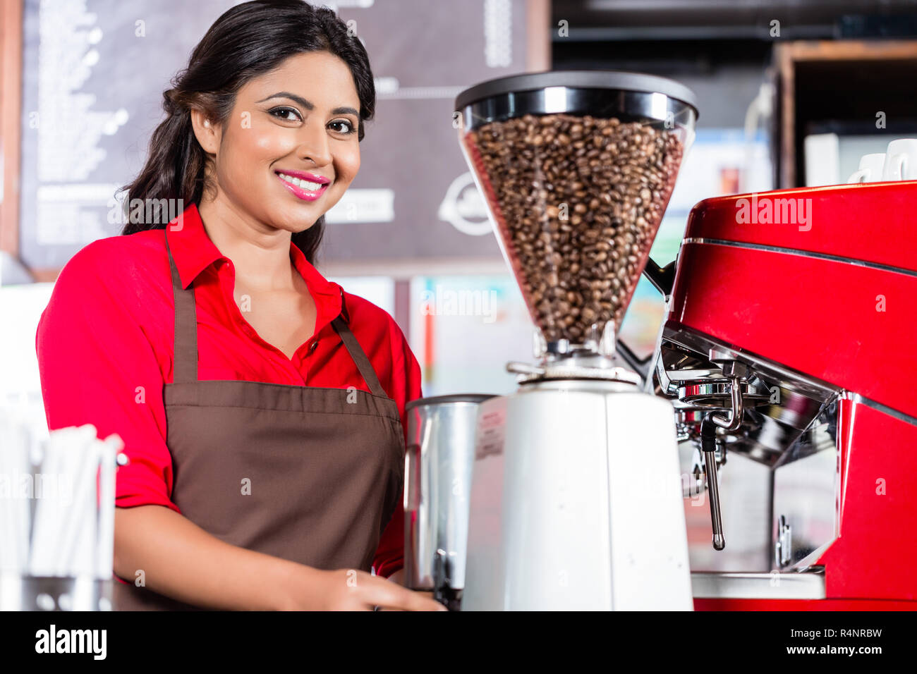 Indian barista offering coffee Stock Photo - Alamy