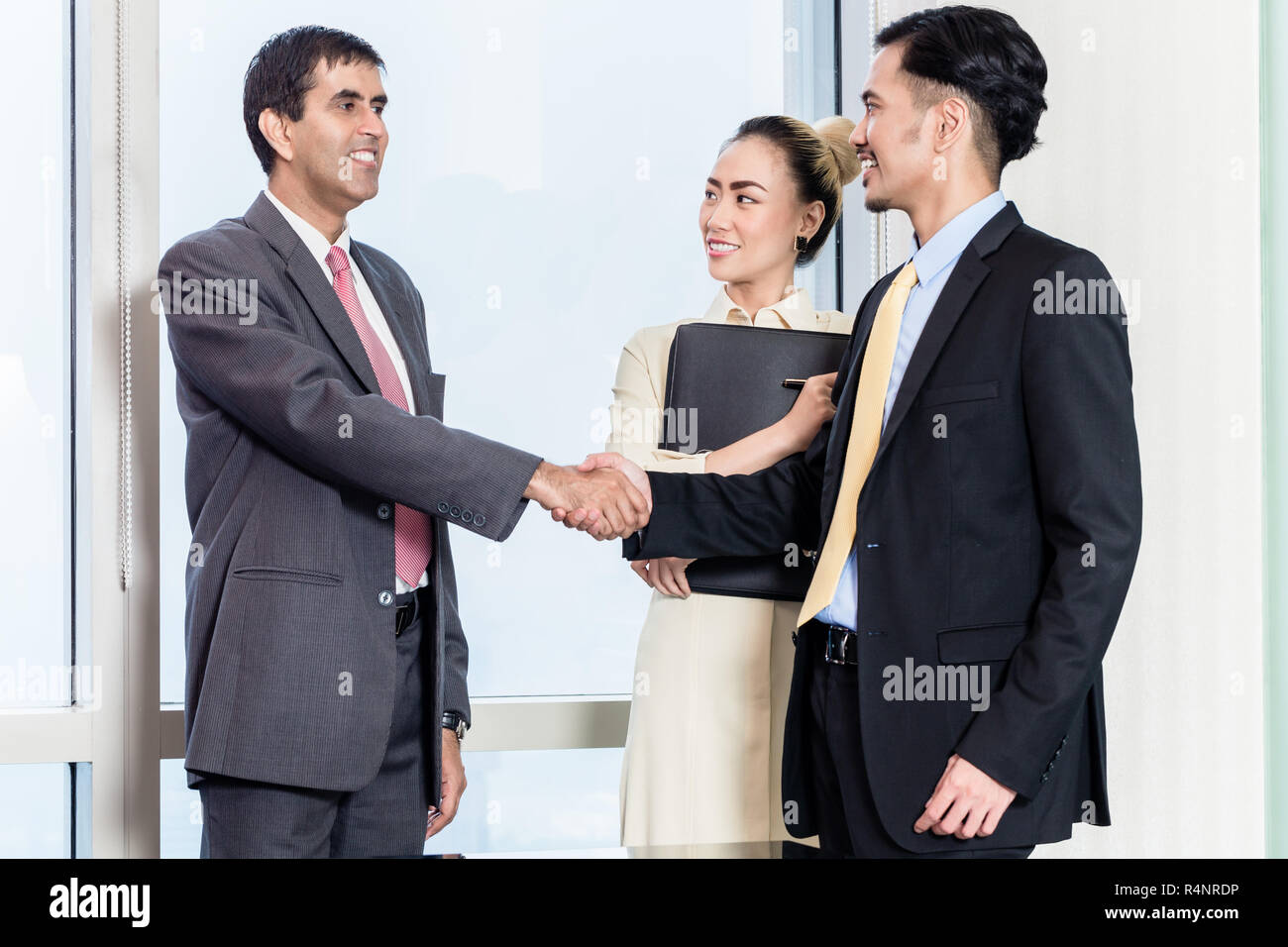 Secretary introduces applicant to boss for job interview Stock Photo ...