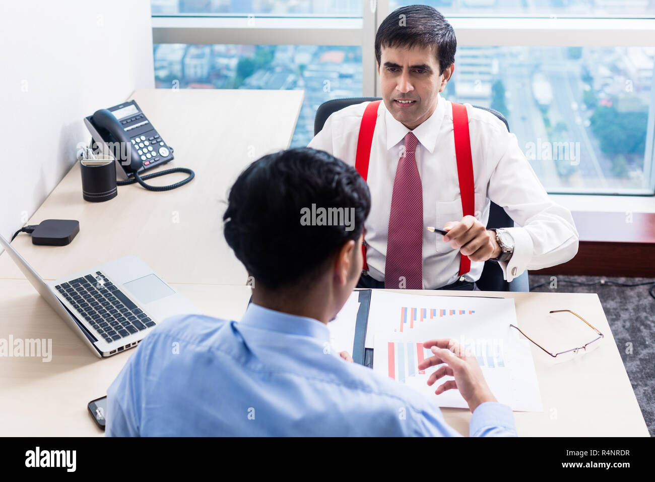 Supervisor talks to subordinate professional in office building Stock ...