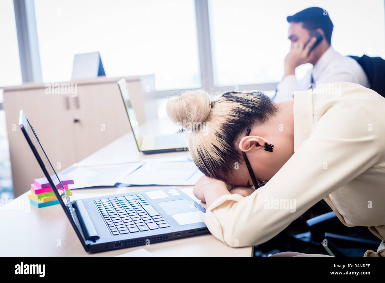 Young businesswoman taking nap in office Stock Photo - Alamy